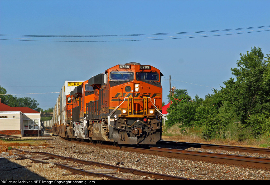 BNSF 6789 Leans into the sun with a hot Z in tow.